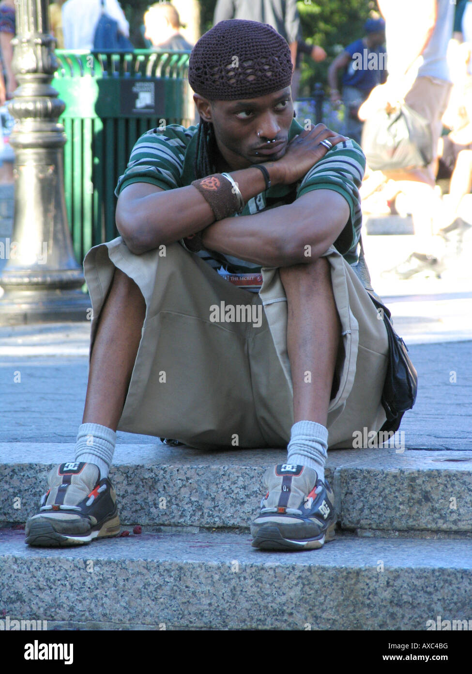 Young man with piercings sitting on stairs at Union Square, USA ...