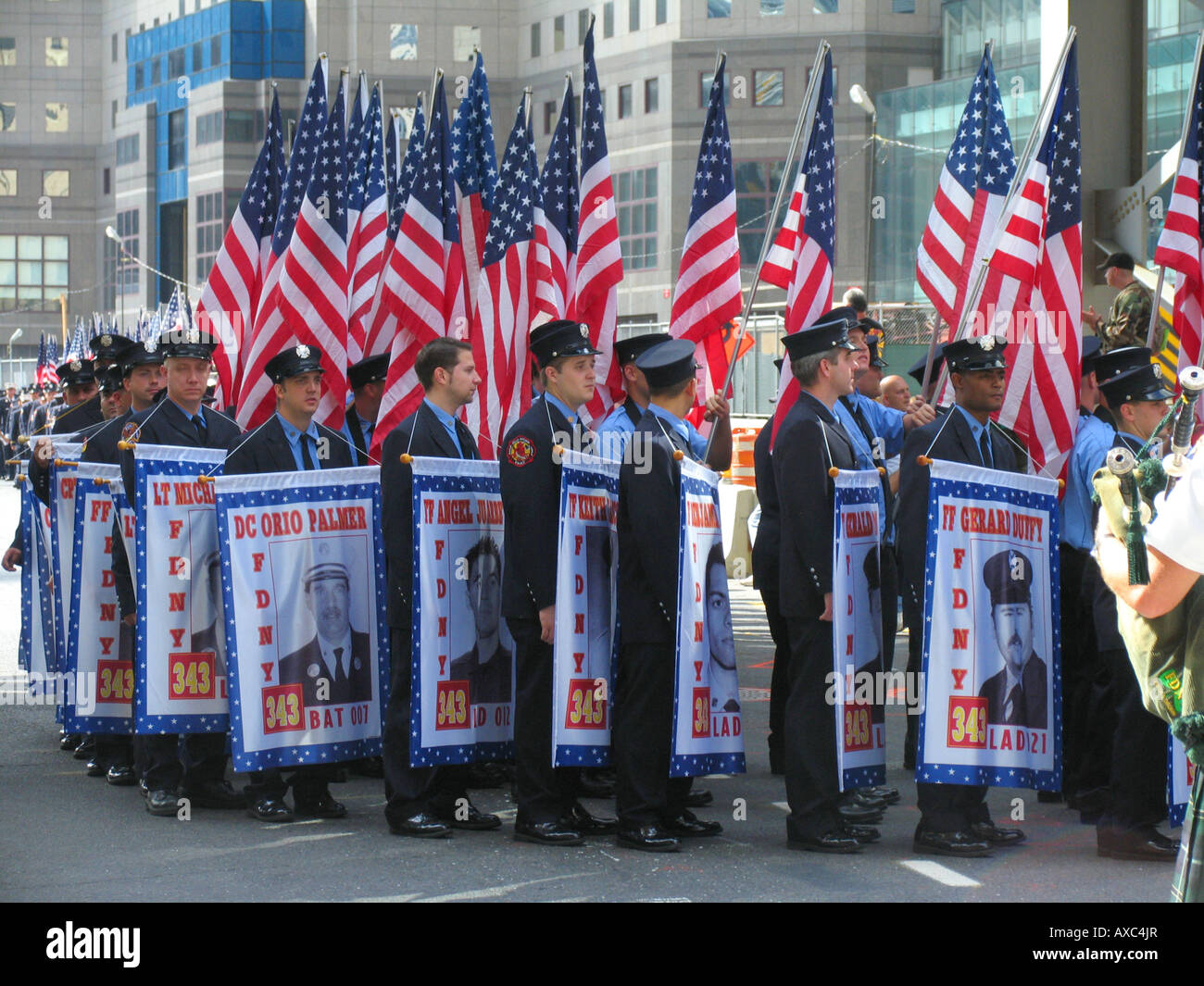 Fire workers with American flags and pictures of late colleagues during ...