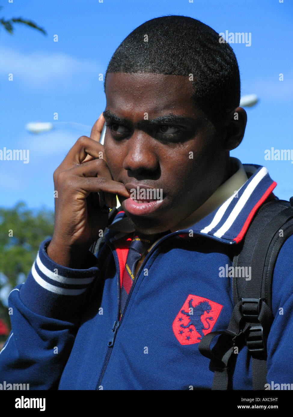 teenager in school uniform speaking on his cell phone, USA, Bronx, New ...