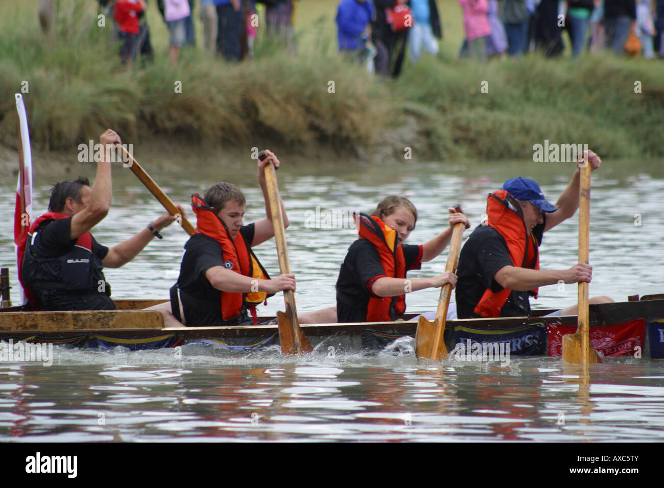 raft race competitors rowing river paddles trying Stock Photo - Alamy