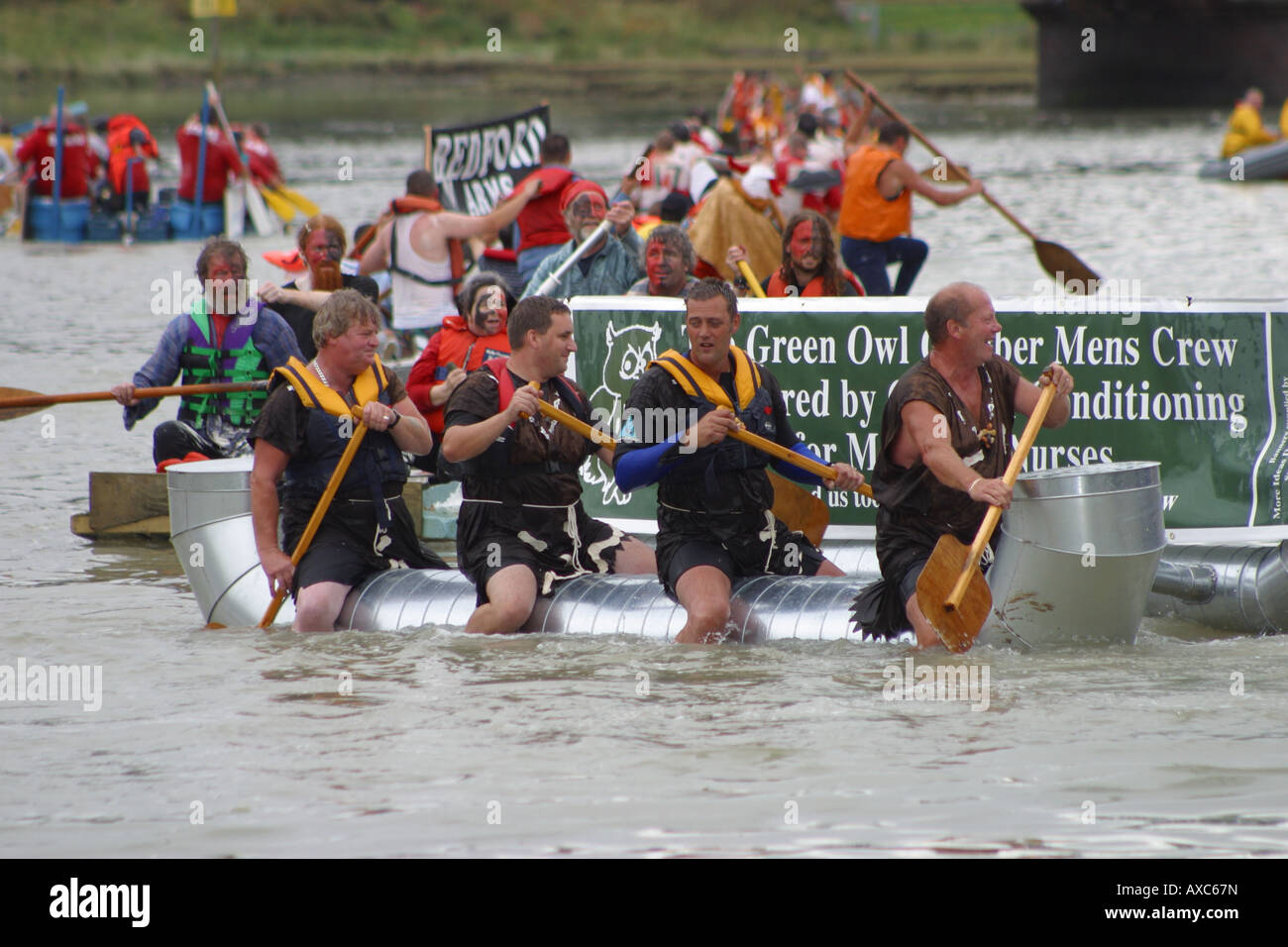 raft race competitors rowing river paddles water Stock Photo - Alamy