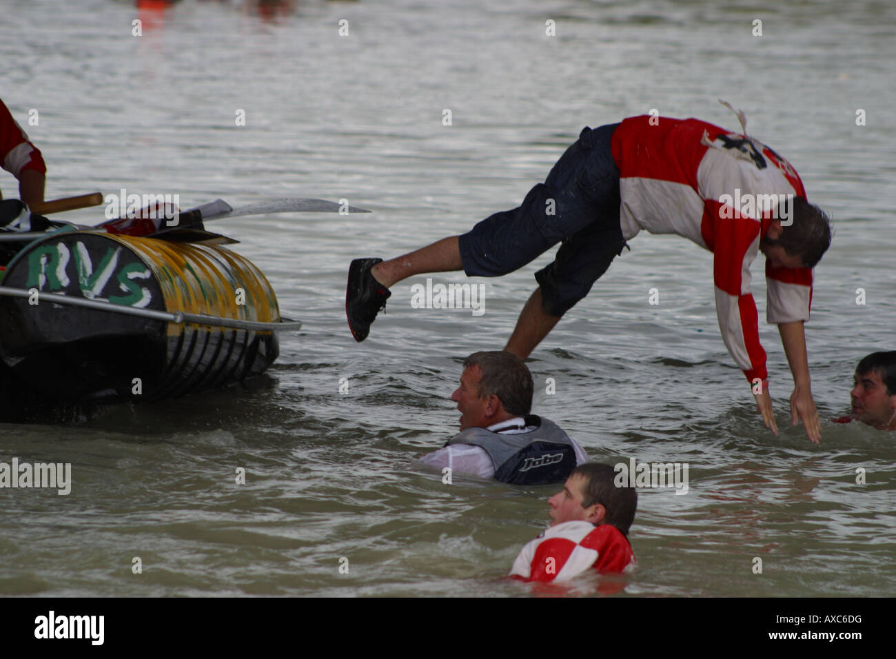 raft race competitors rowing river diving in float Stock Photo - Alamy