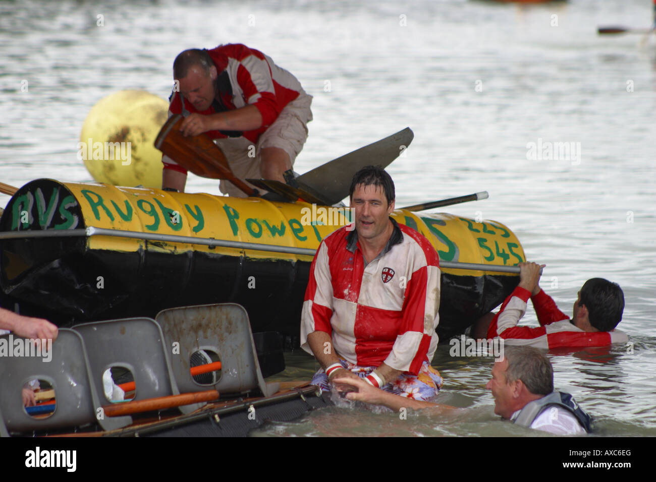 raft race competitors rowing river oars swimming Stock Photo - Alamy