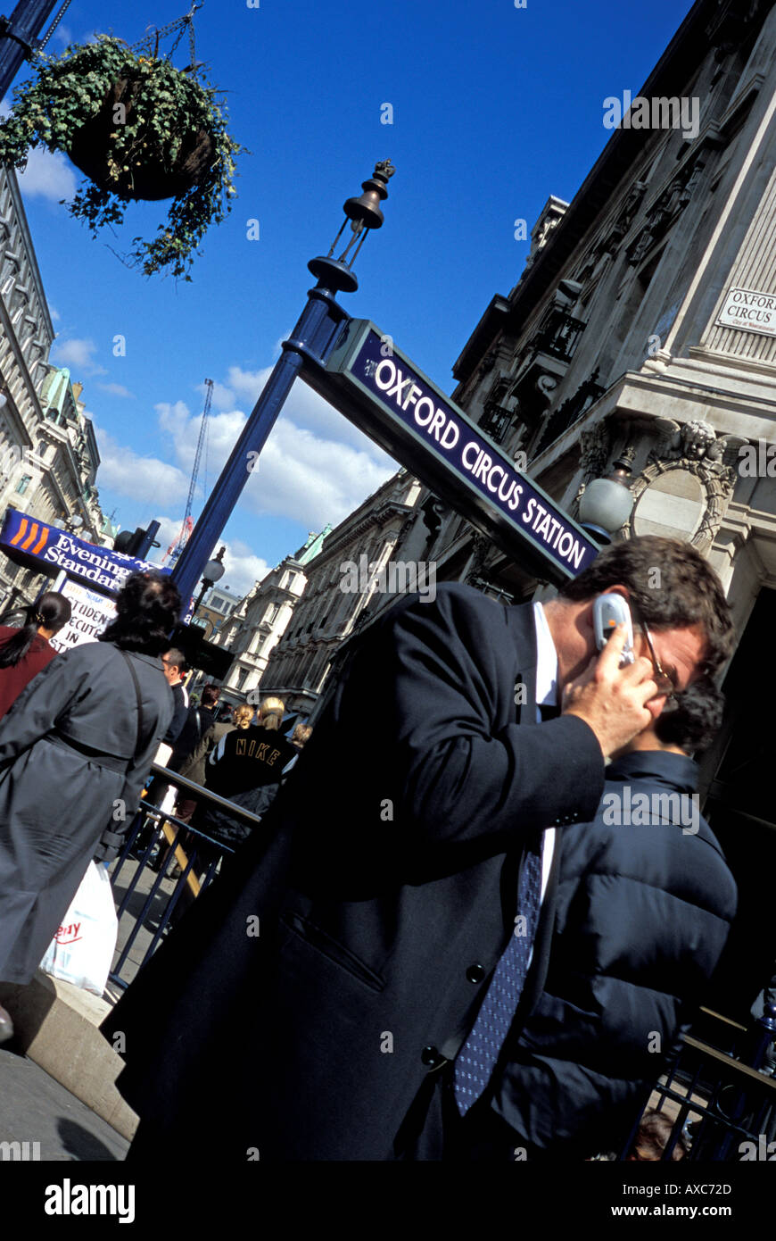 Man using mobile phone at Oxford Circus Tube station London England man ...