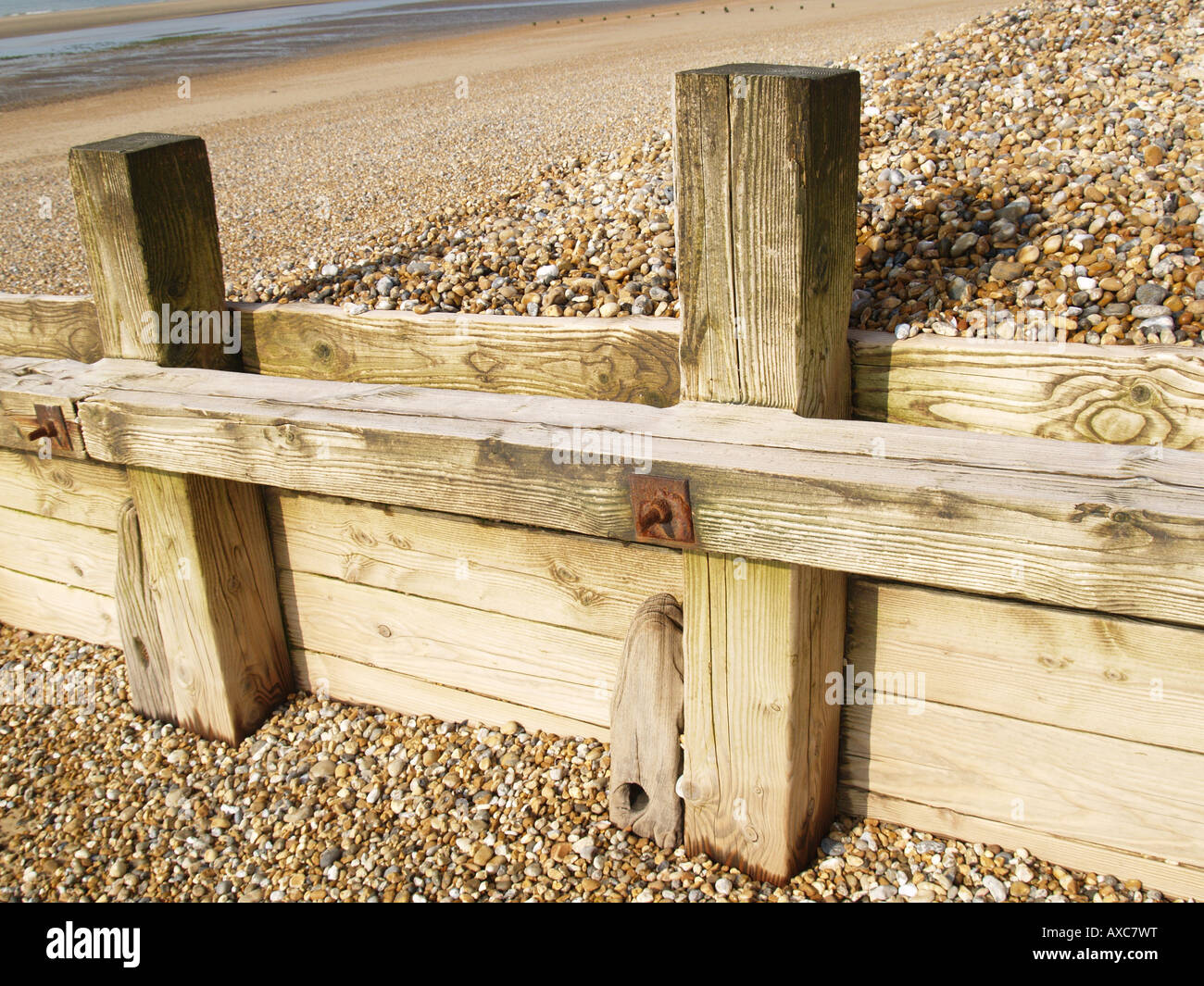 pebble wooden wood sea defence low tide beach camber sands kent england ...