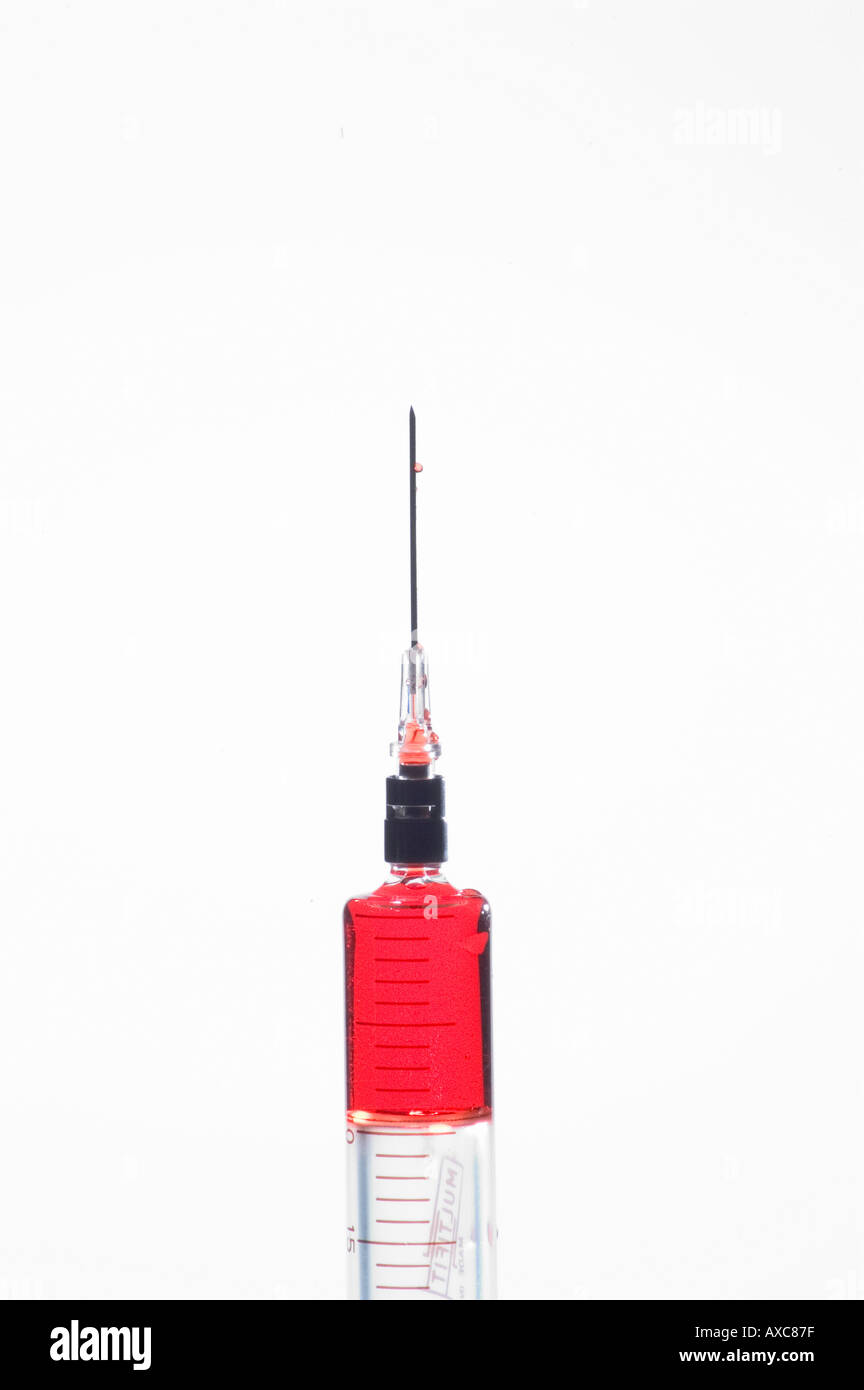 Hypodermic syringe with red liquid and needle Stock Photo - Alamy