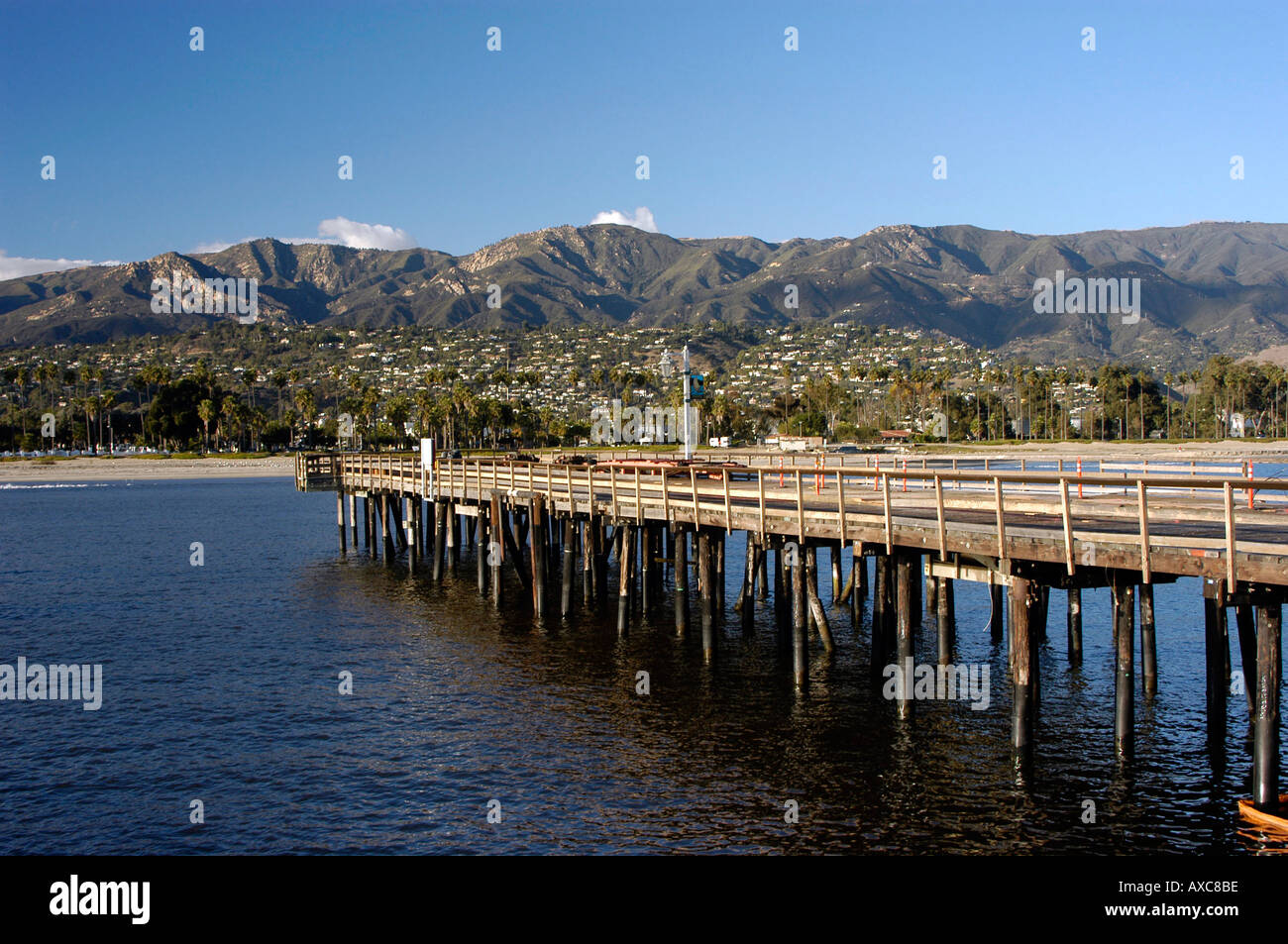 Wharf at the Santa Barbara California harbor with city and mountains in ...
