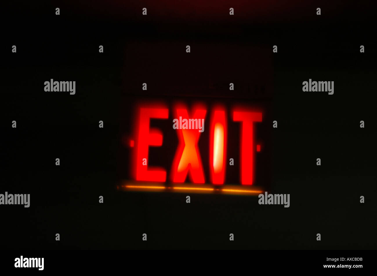 Red Exit sign with dark building interior. Taken with a toy camera for ...