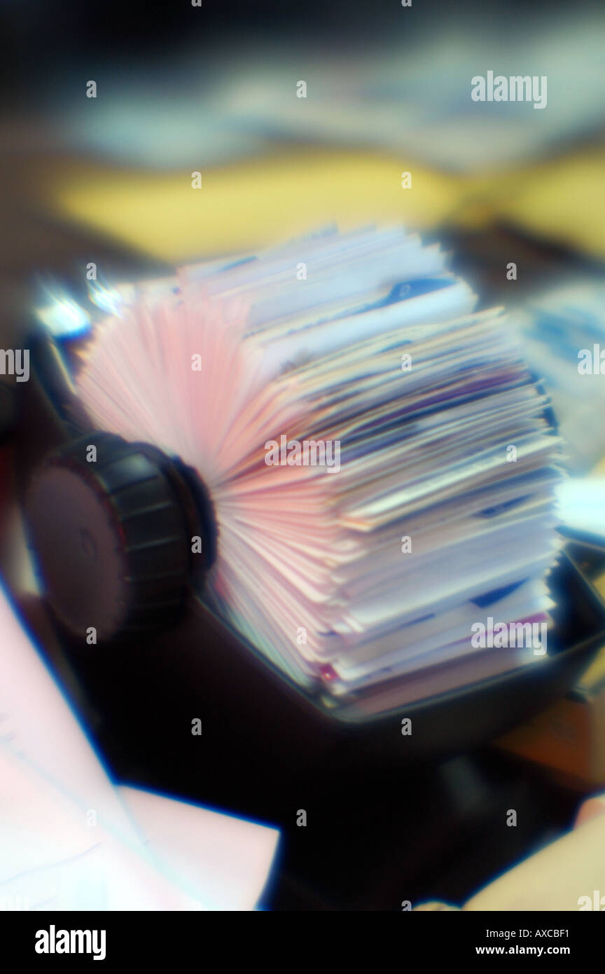 Rolodex style contact organizer on cluttered office desk Stock Photo ...