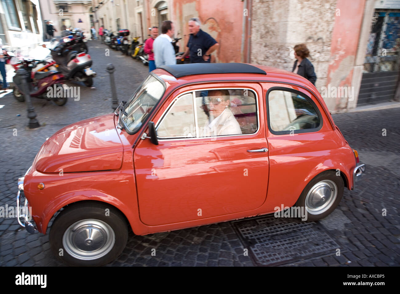 Red Fiat 500 driving through L Aquila Abruzzo Italy Stock Photo - Alamy