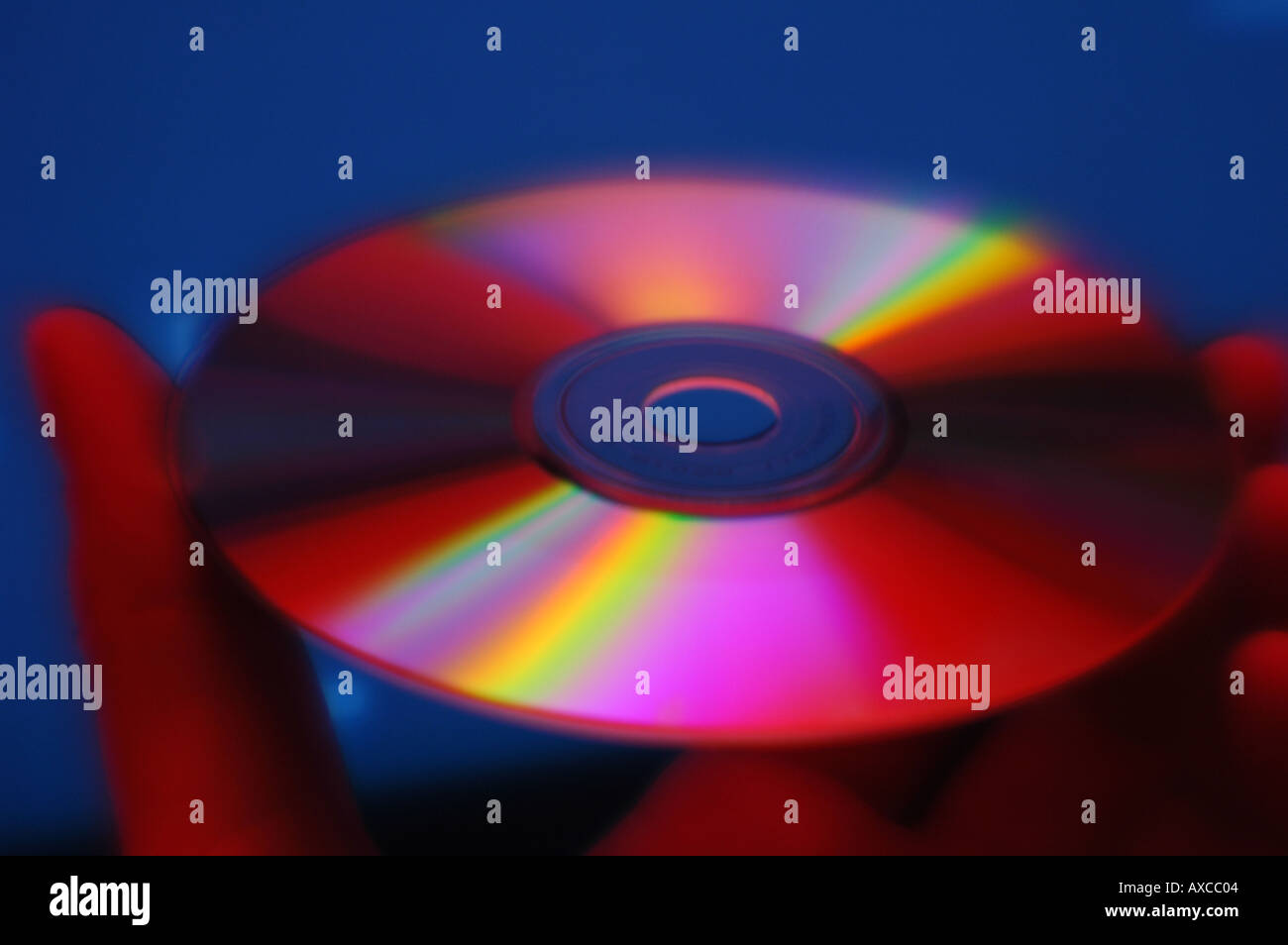 Computer disc in hand with red and blue saturated colors Stock Photo ...