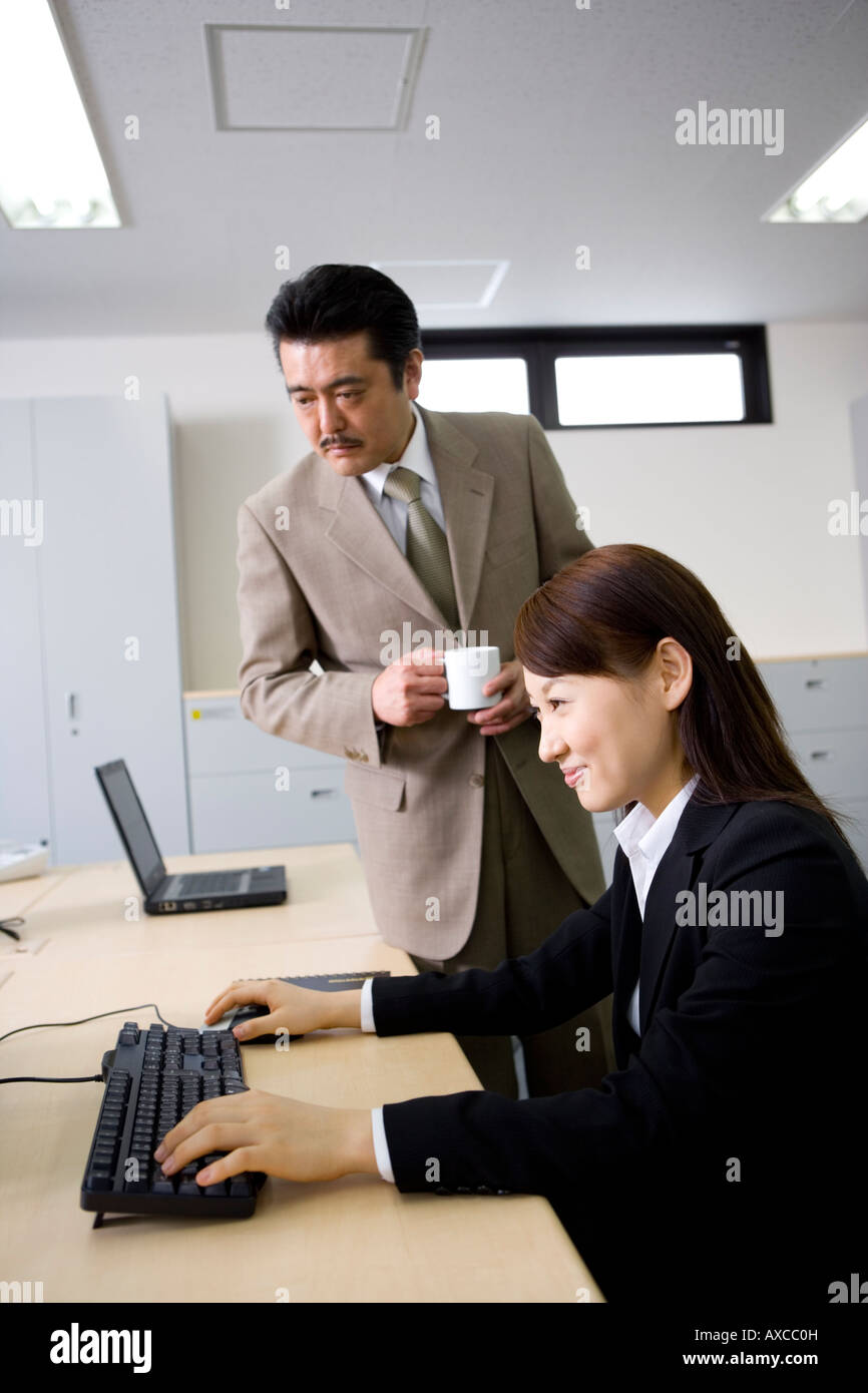 Two people working in office Stock Photo - Alamy