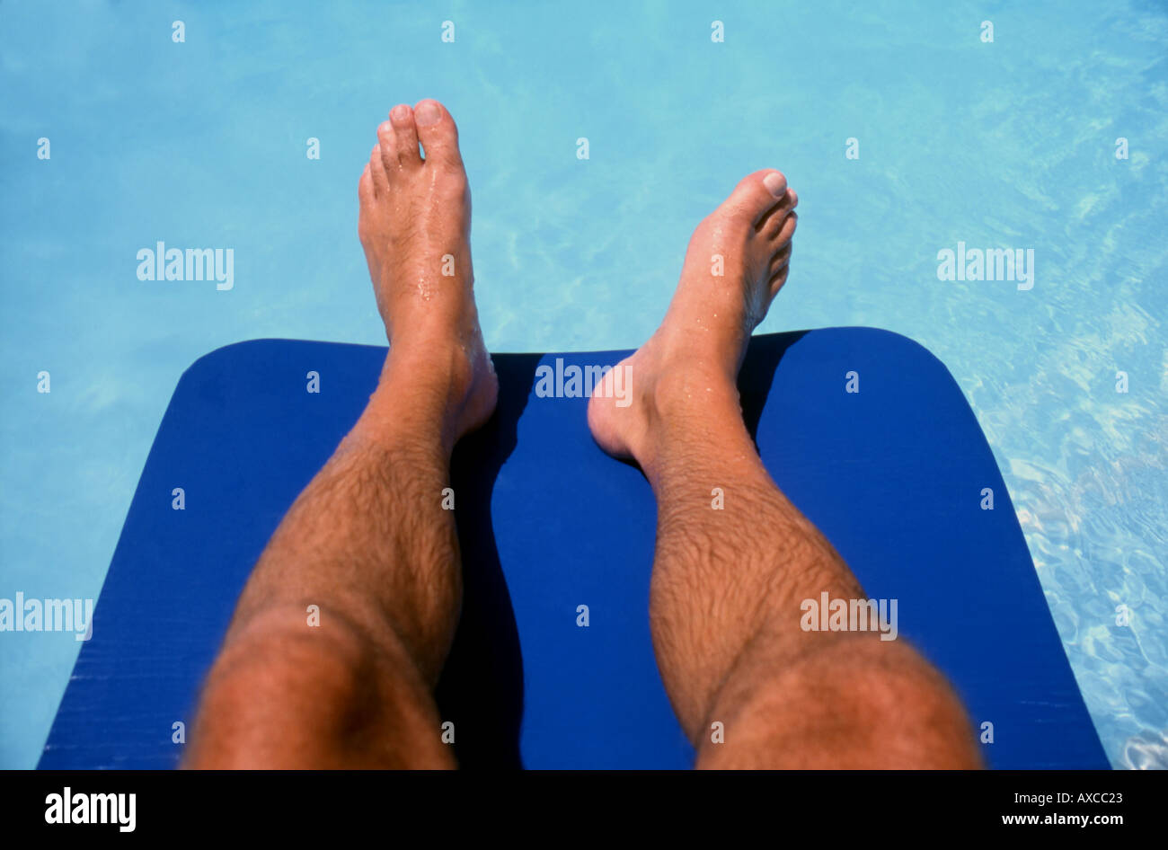 Legs on Swimming Pool Float Stock Photo - Alamy