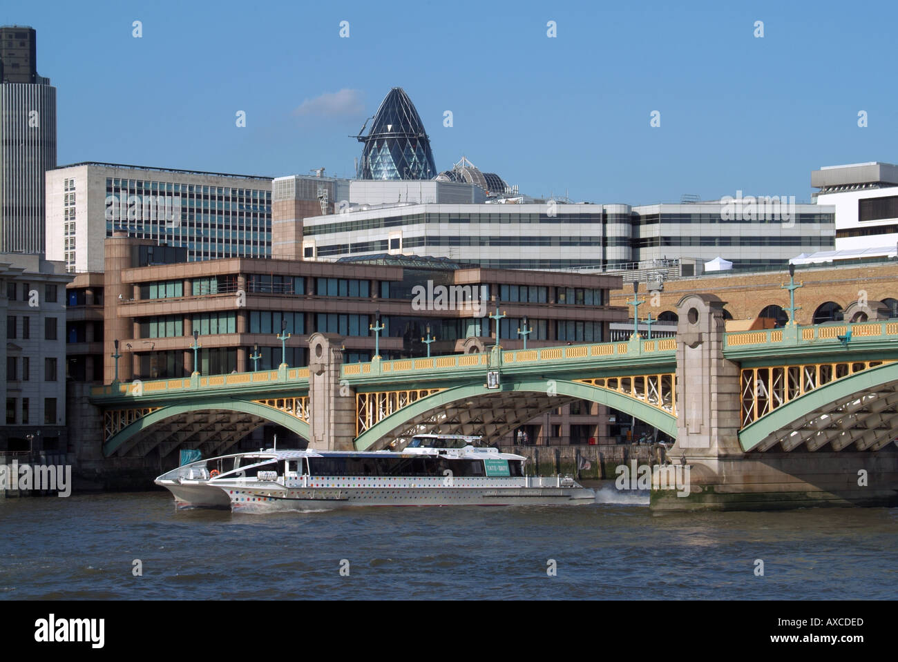 London river Thames fast catamaran passing under Southwark road Bridge ...