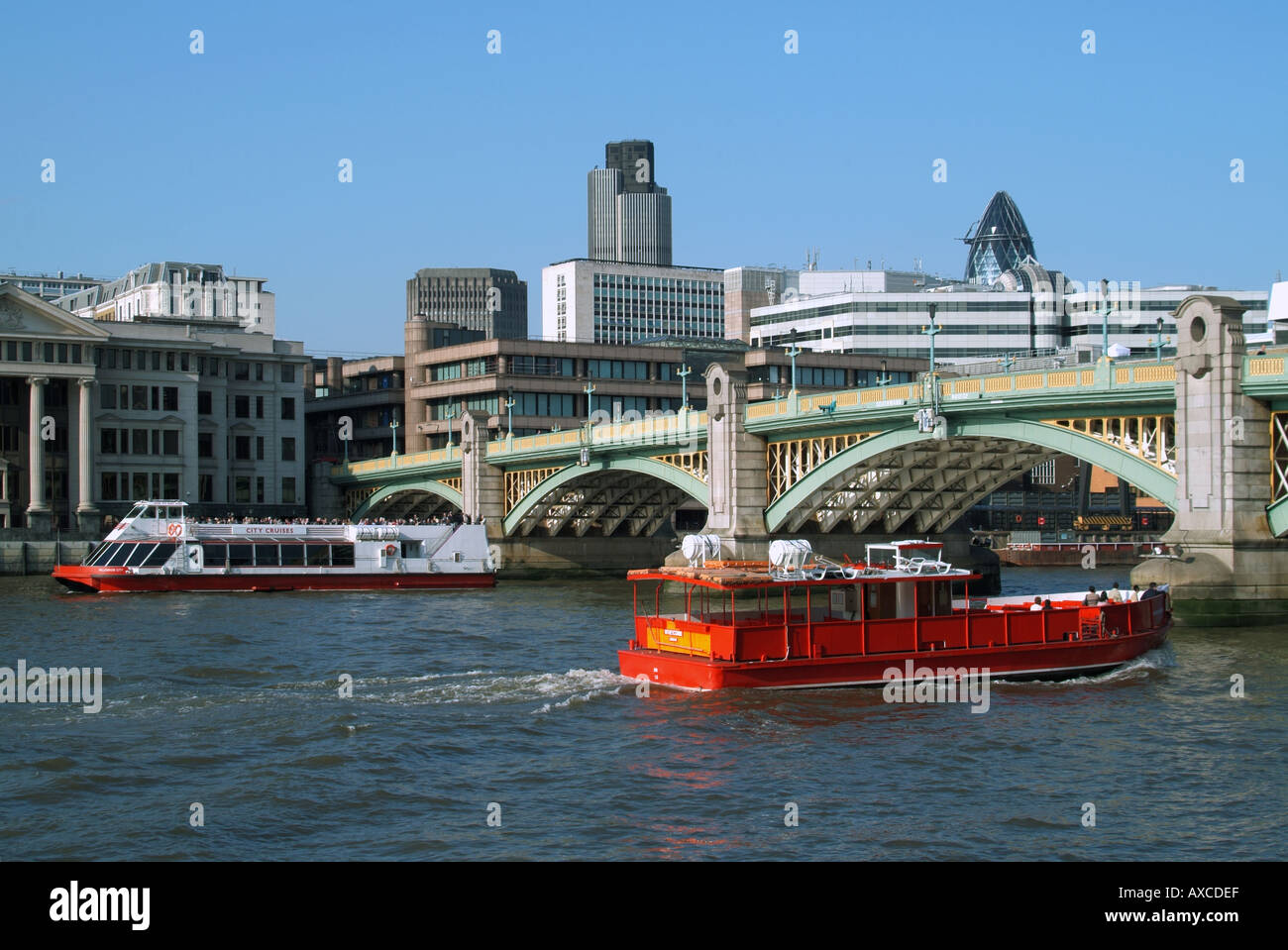 London river Thames tour boats close to Southwark road Bridge with ...