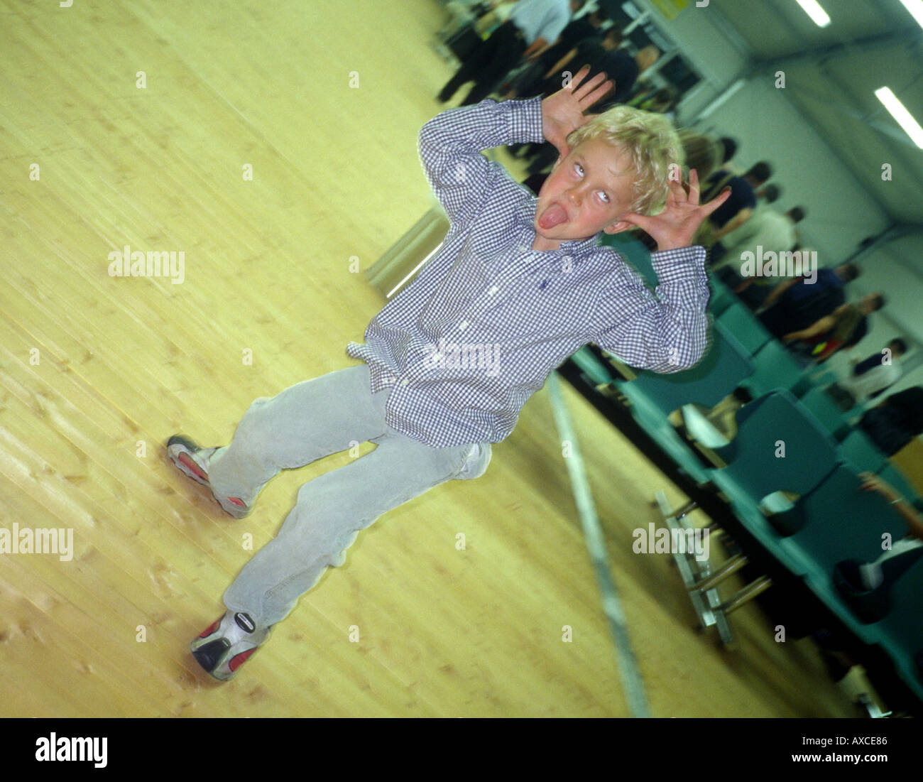 Mocking boy sticking tongue out in airport Stock Photo - Alamy