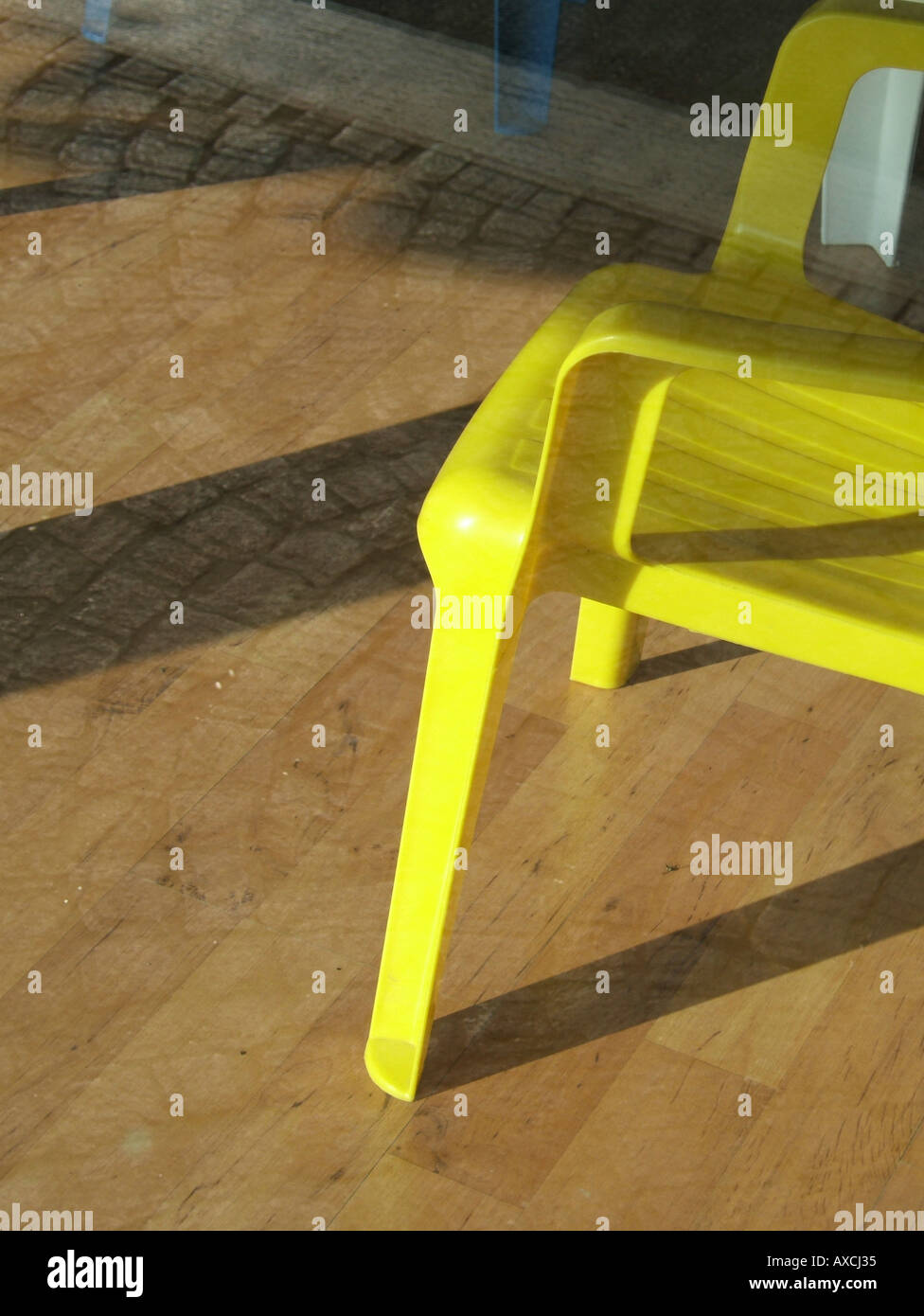 yellow plastic chair Stock Photo - Alamy