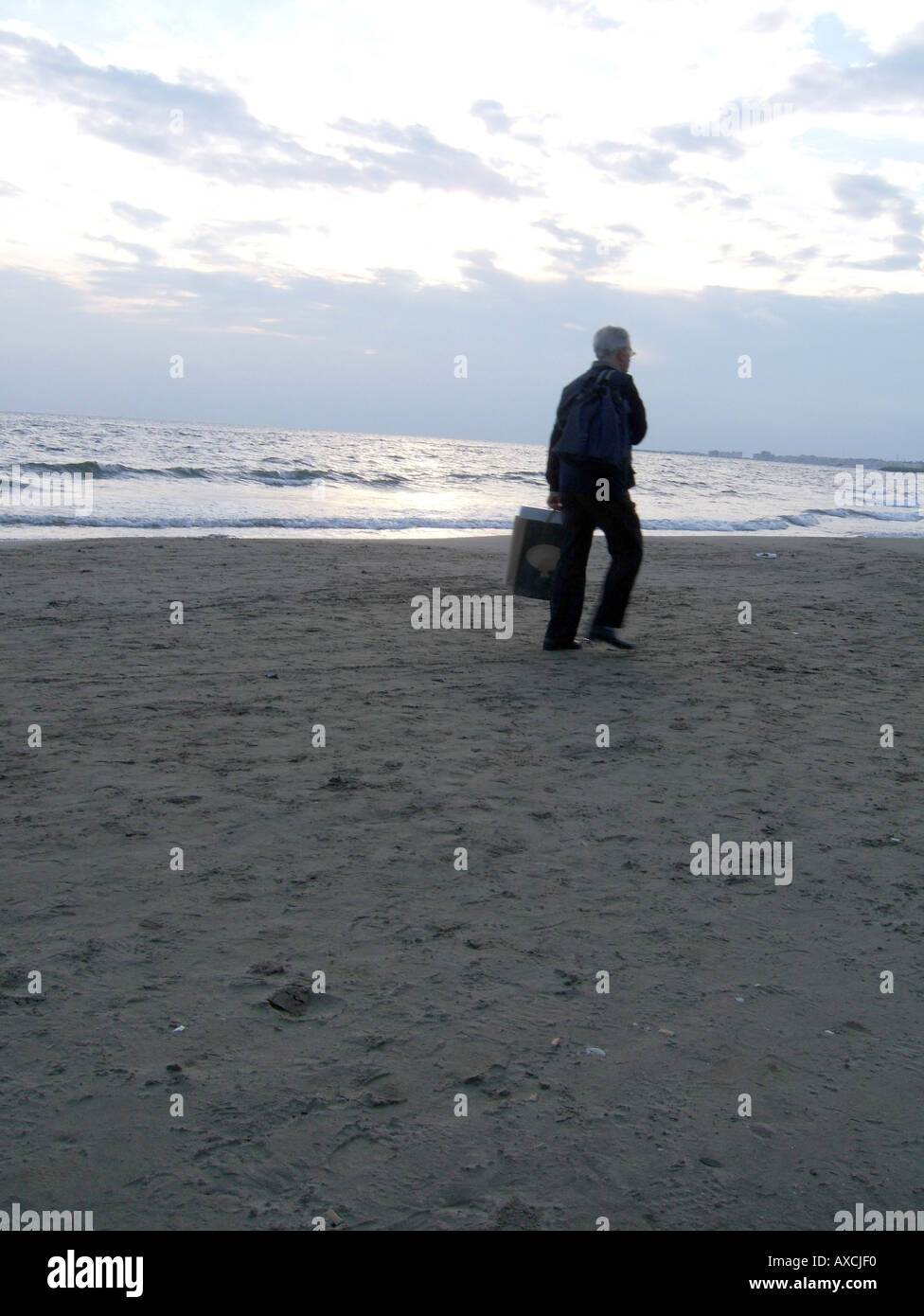 person walking on beach Stock Photo - Alamy