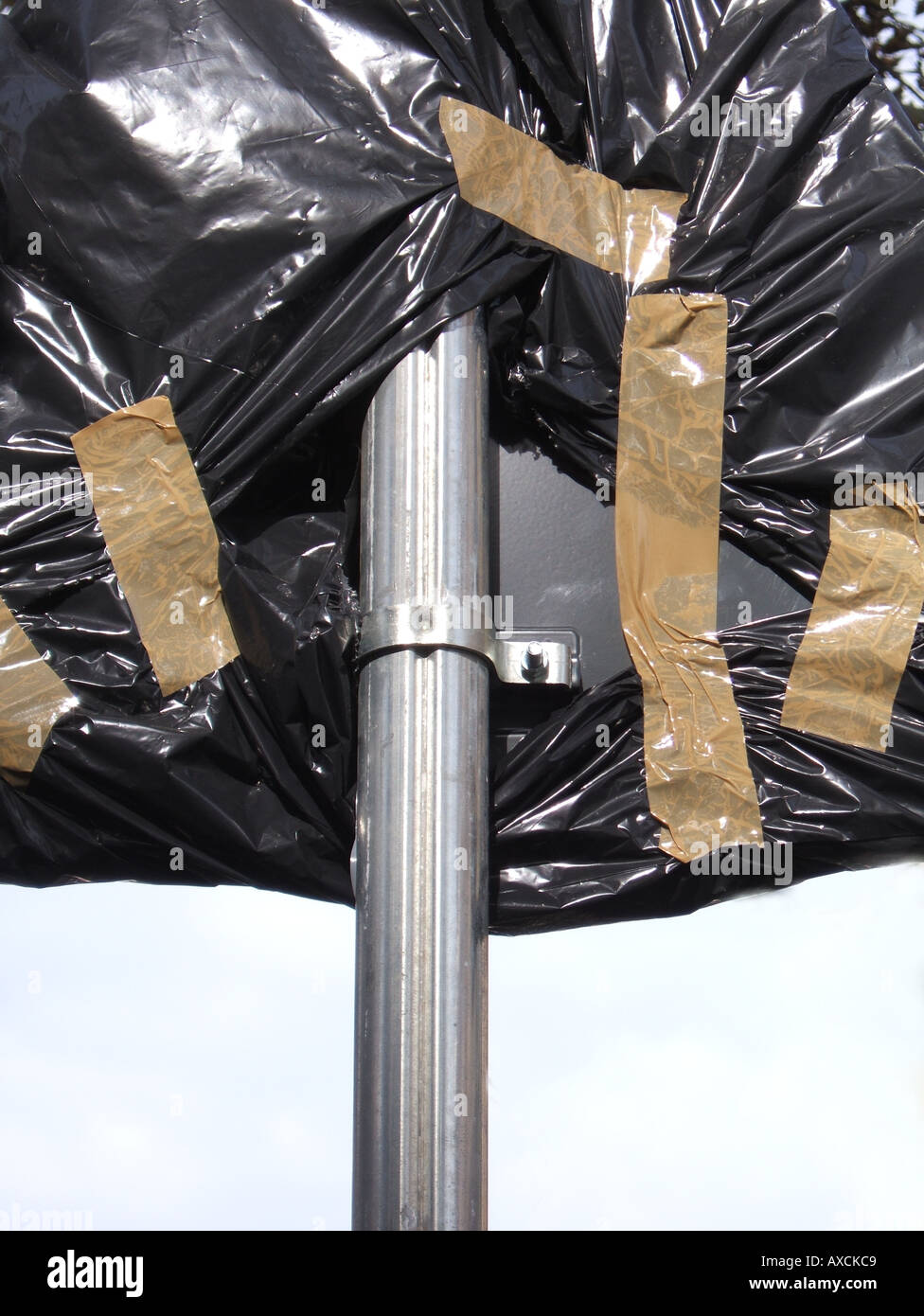 triangle road sign covered with plastic bag Stock Photo - Alamy
