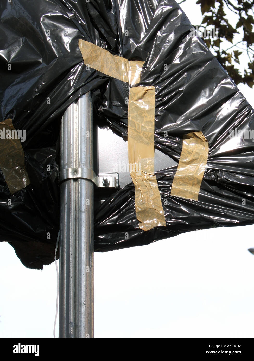 triangle road sign covered with plastic bag Stock Photo - Alamy
