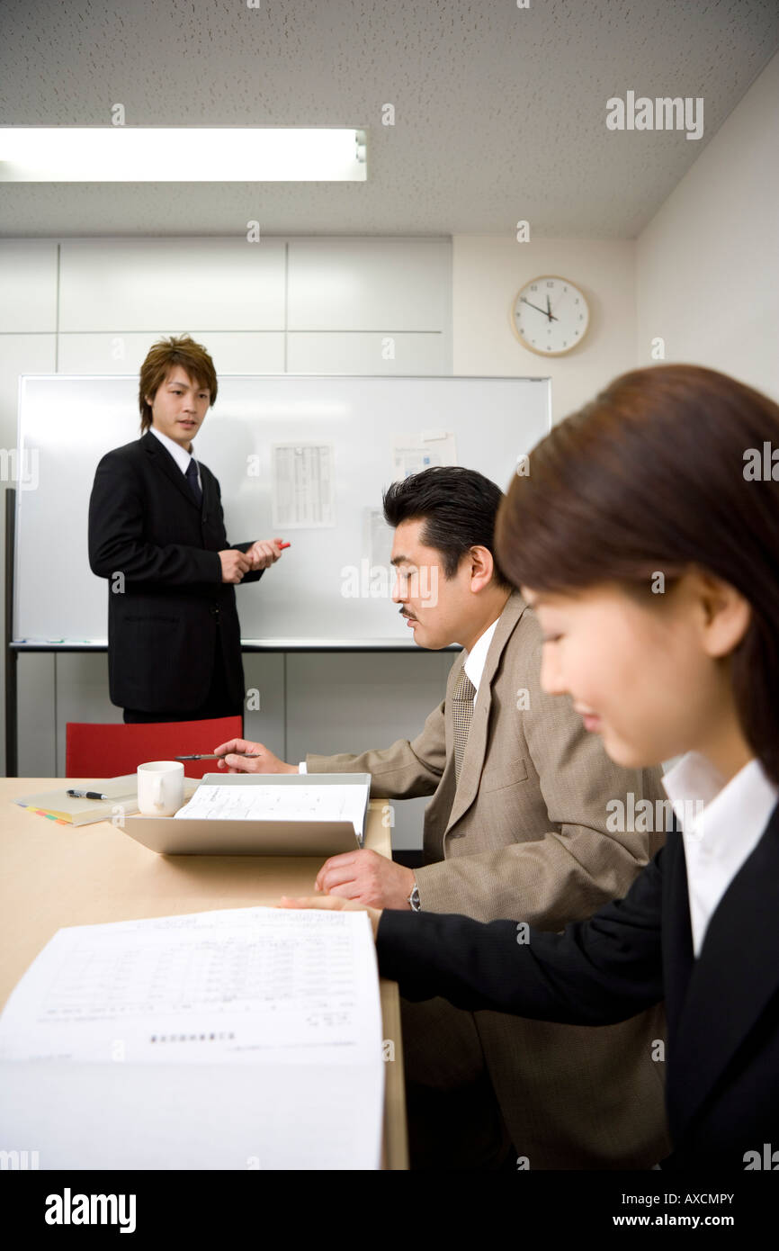 Three people discussing in meeting room Stock Photo - Alamy