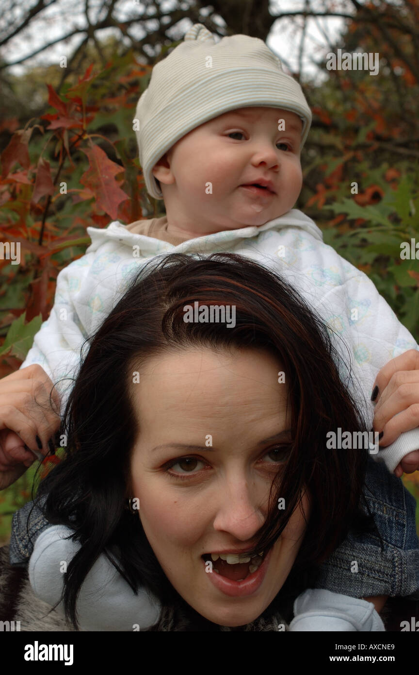 Cute baby on mother's shoulders Stock Photo - Alamy