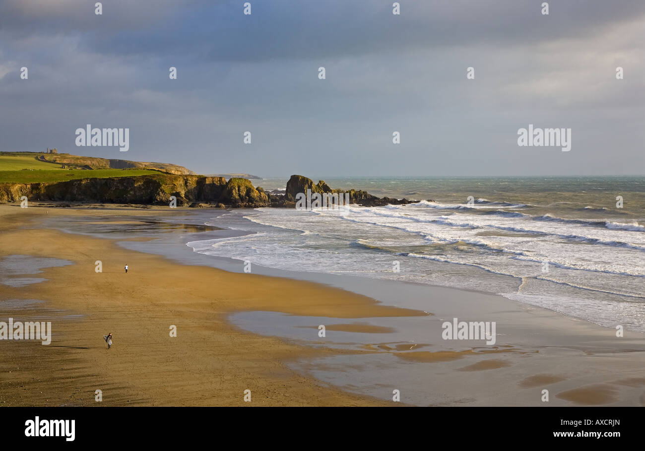 People on stormy Bunmahon Strand, The Copper Coast, County Waterford ...