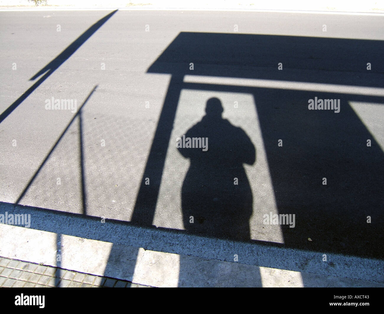 shadow of man waiting at bus stop Stock Photo - Alamy