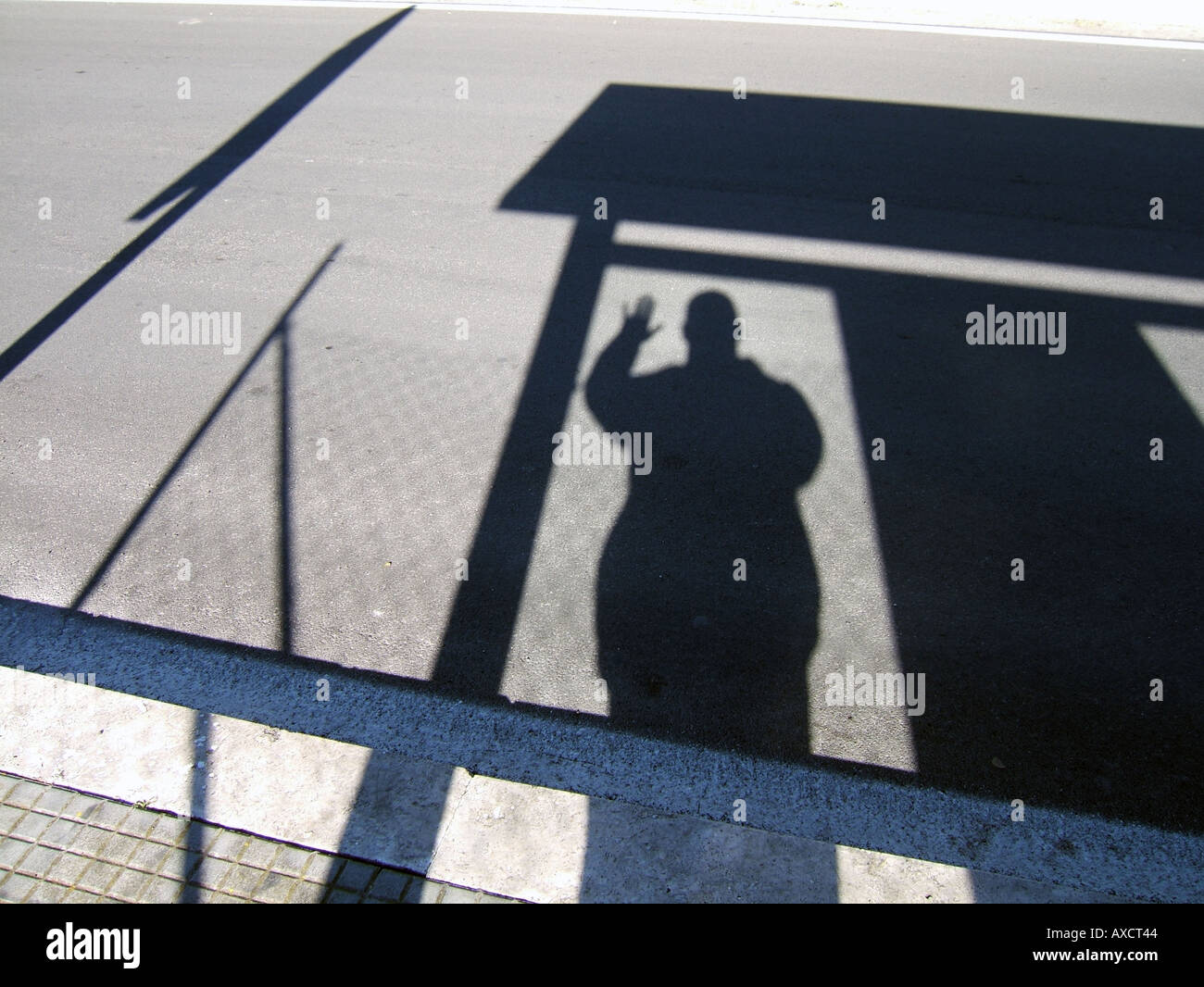 shadow of man waiting at bus stop Stock Photo - Alamy