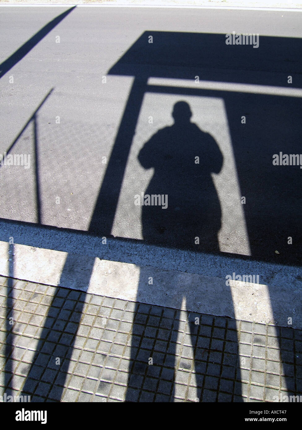 shadow of man waiting at bus stop Stock Photo - Alamy