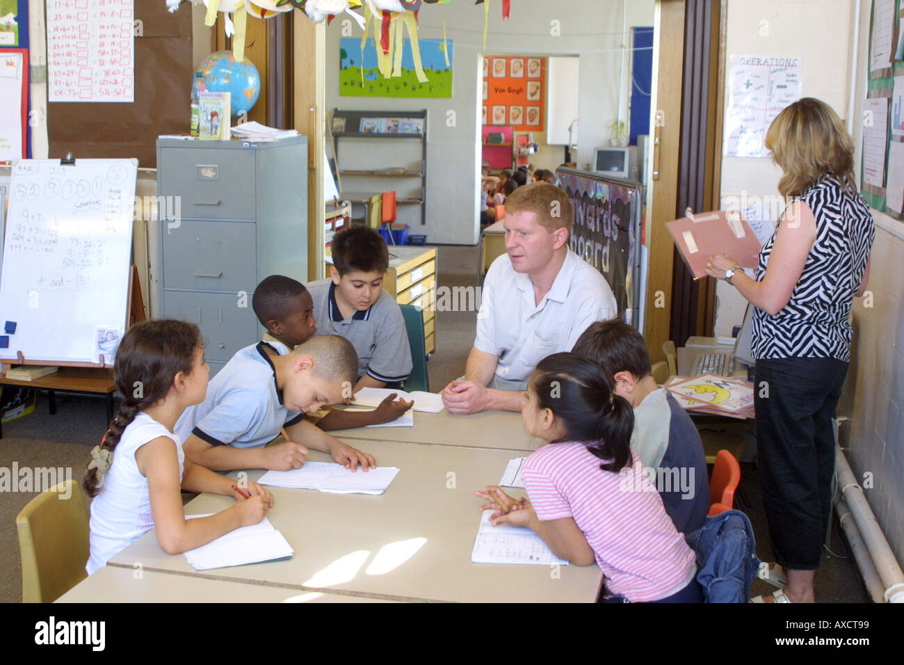 Primary school teacher teaching students math Stock Photo - Alamy