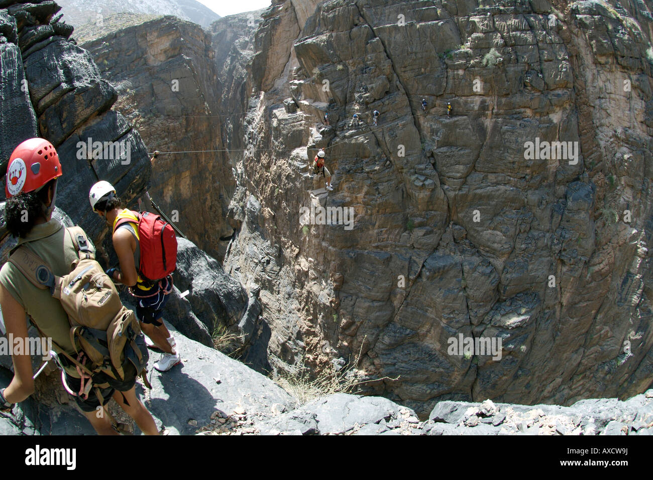 A hiker traversing a zip wire (a.k.a. flying fox) on the Via Ferrata ... A hiker traversing a zip wire (a.k.a. flying fox) on the Via Ferrata ...