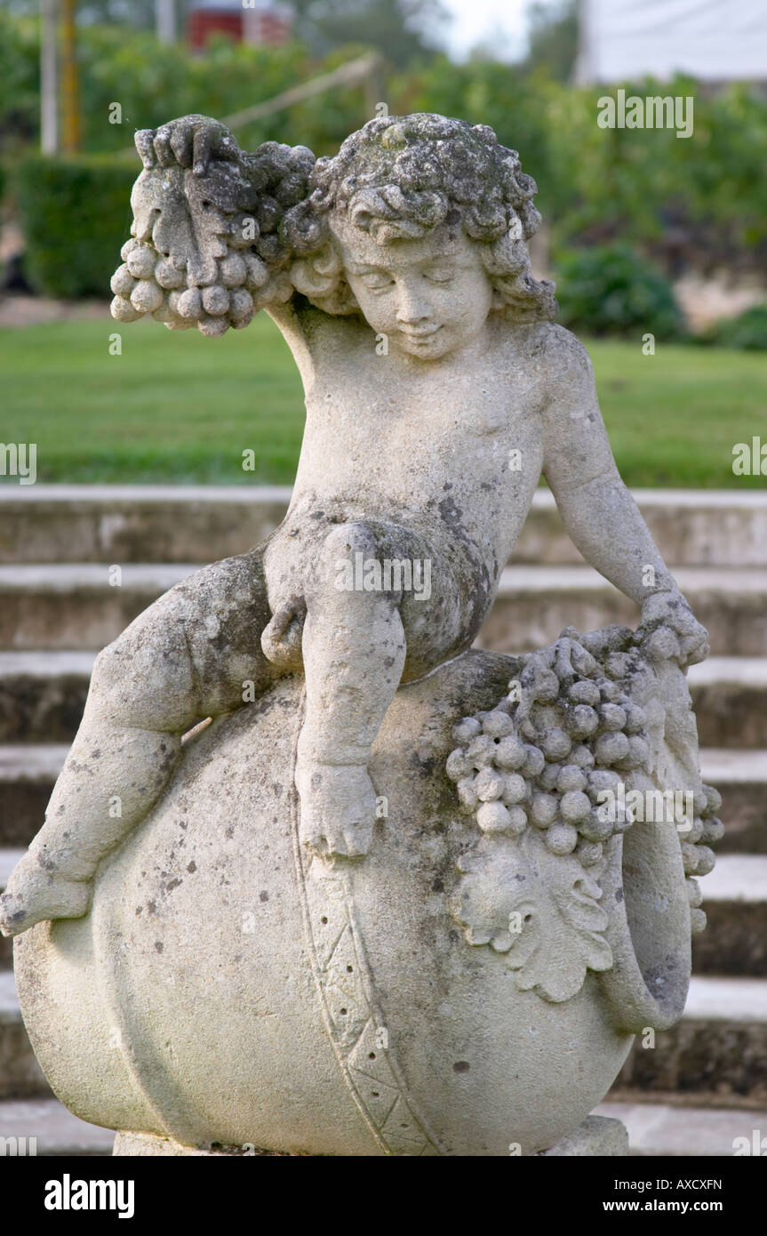 Statue of Bacchus, grape bunch. In the garden. Chateau Malartic ...