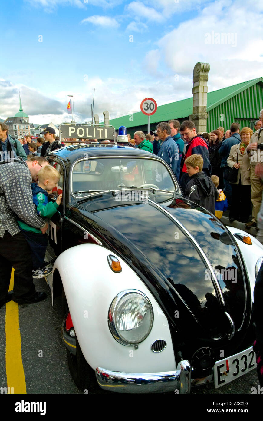 People watching a classic Volskwagen Beetle police car.Bergen.Norway ...
