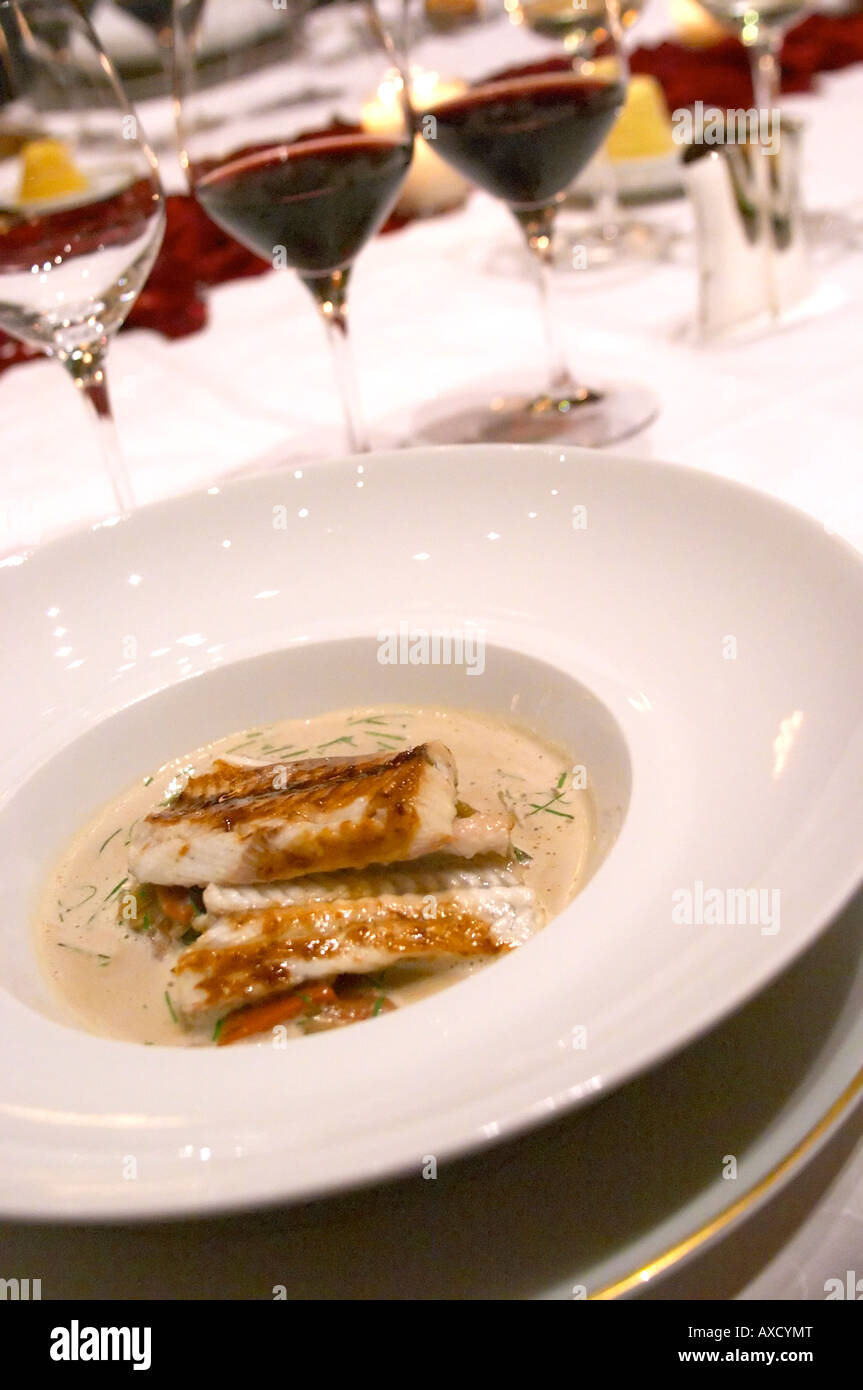 Dinner in the George V luxury restaurant in Paris. Fish in a white wine ...
