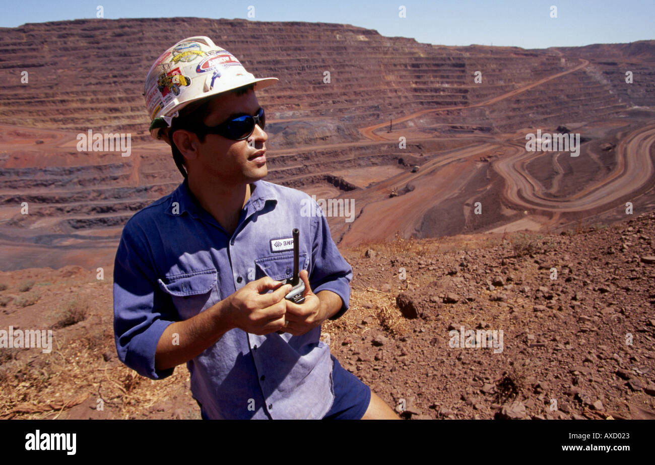 Young Indigenous aboriginal australian male worker with mobile at BHP ...