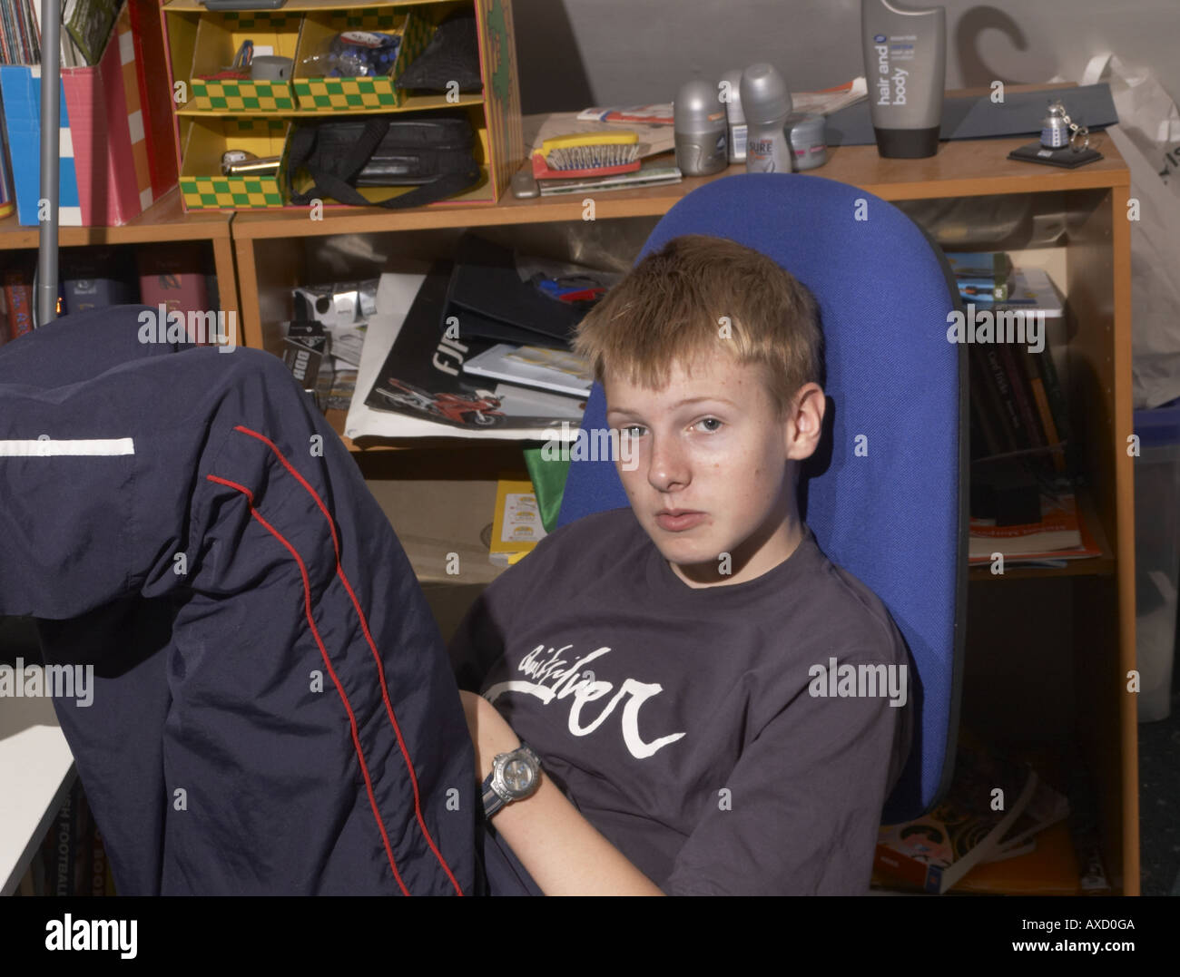 teenage boy slouching in untidy bedroom Stock Photo - Alamy