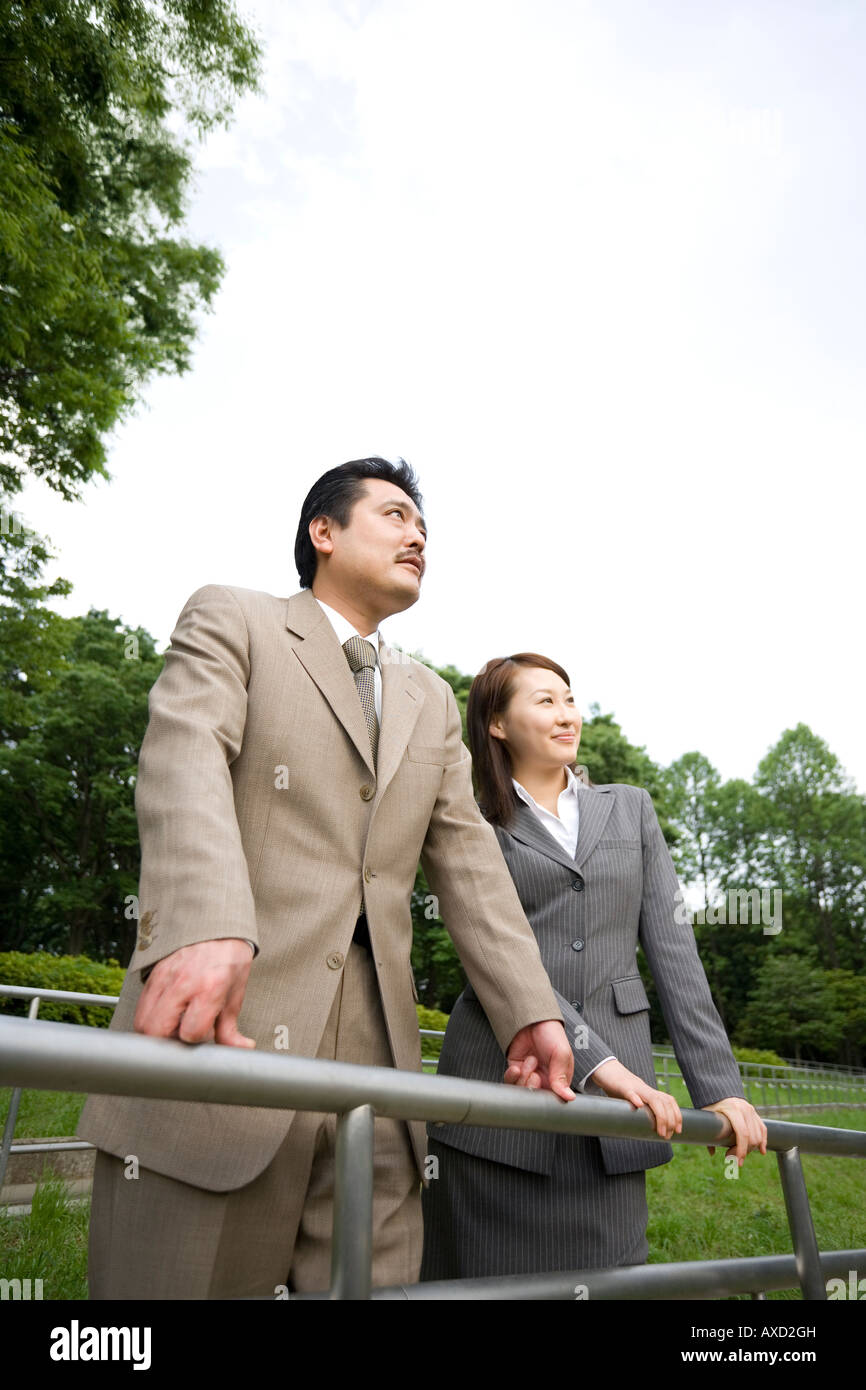 Two business people standing Stock Photo - Alamy