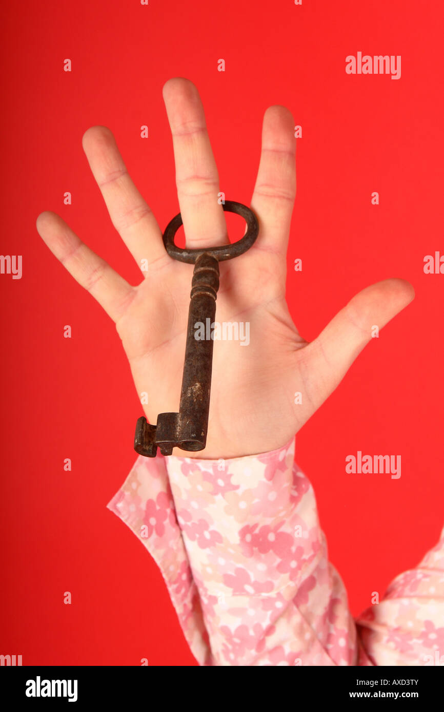 Female girl hand holding large old key Stock Photo - Alamy