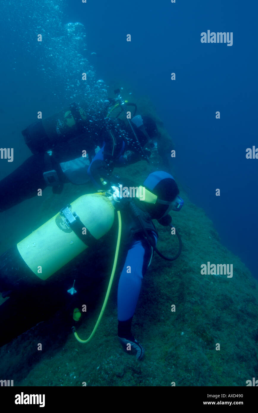Two scuba divers looking deep down into the ocean near Ile de Riou ...