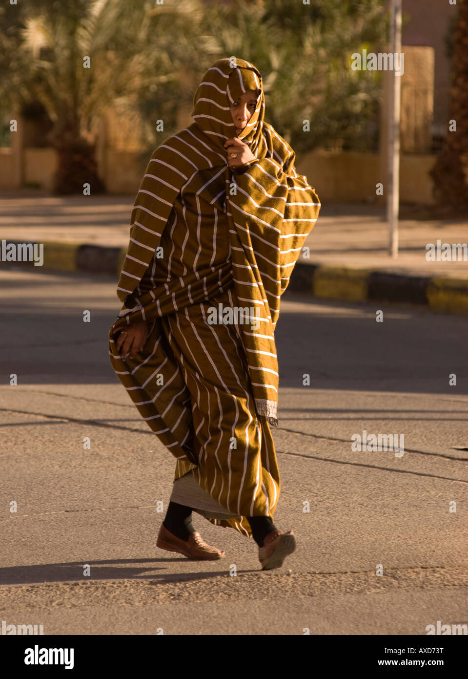Arabic woman walking in the modern town of Ghadames Libya Stock Photo ...