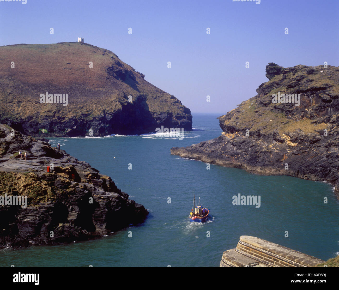 Fishing boat heading to sea out of the deep inlet at Boscastle on the ...