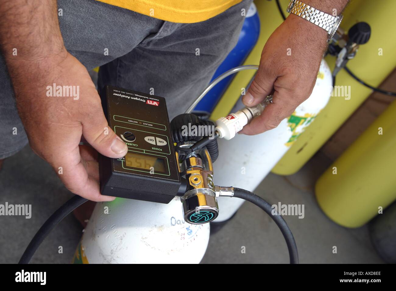 This diver MR is testing his nitrox tank with an oxygen analizer to ...