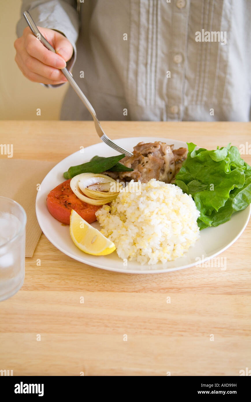 Woman eating grilled pork Stock Photo - Alamy