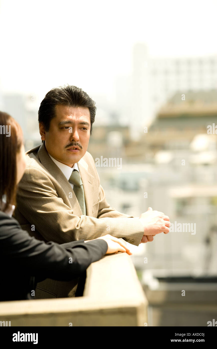 Two business people talking Stock Photo - Alamy