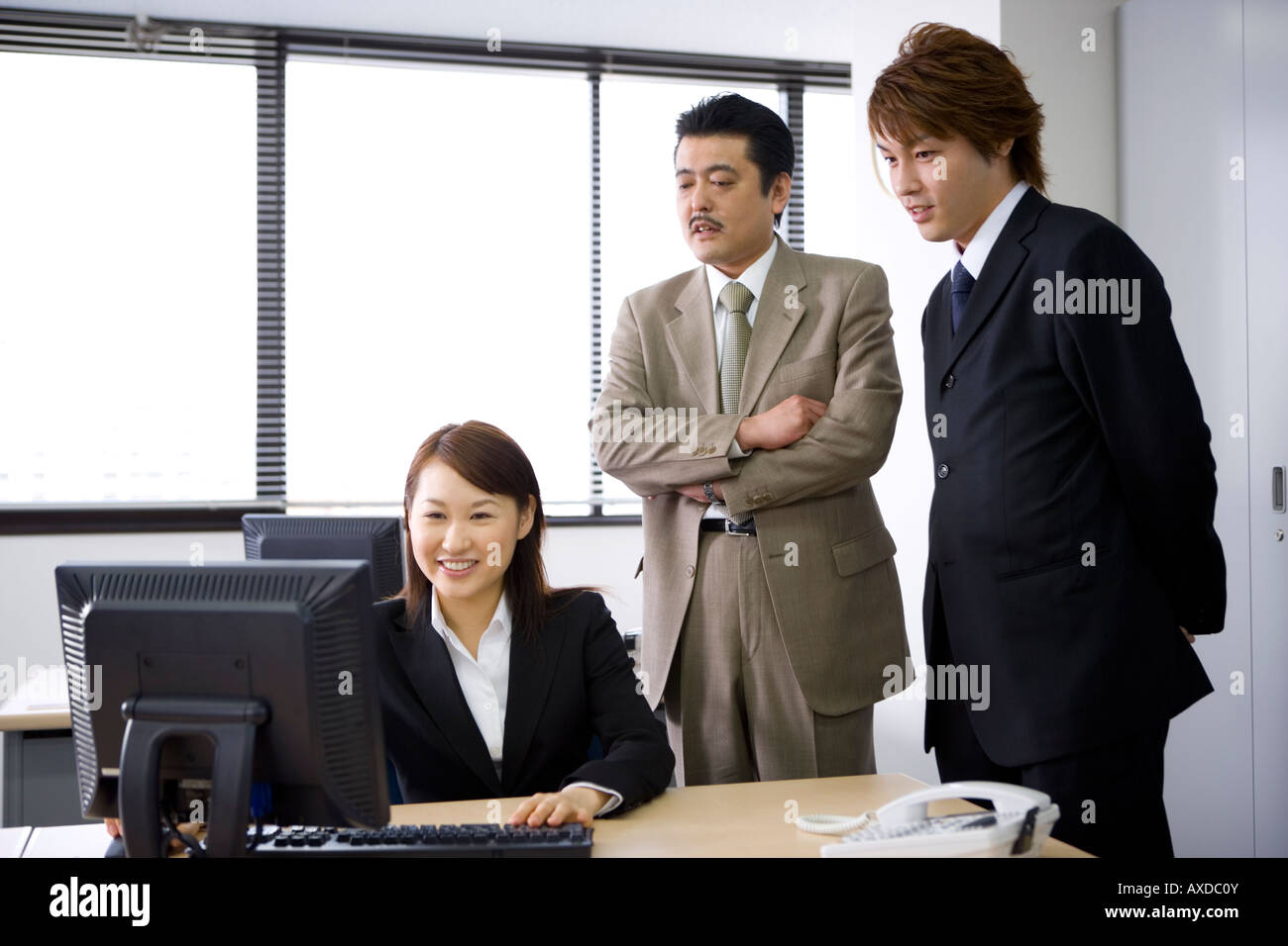 Three people working in office Stock Photo - Alamy