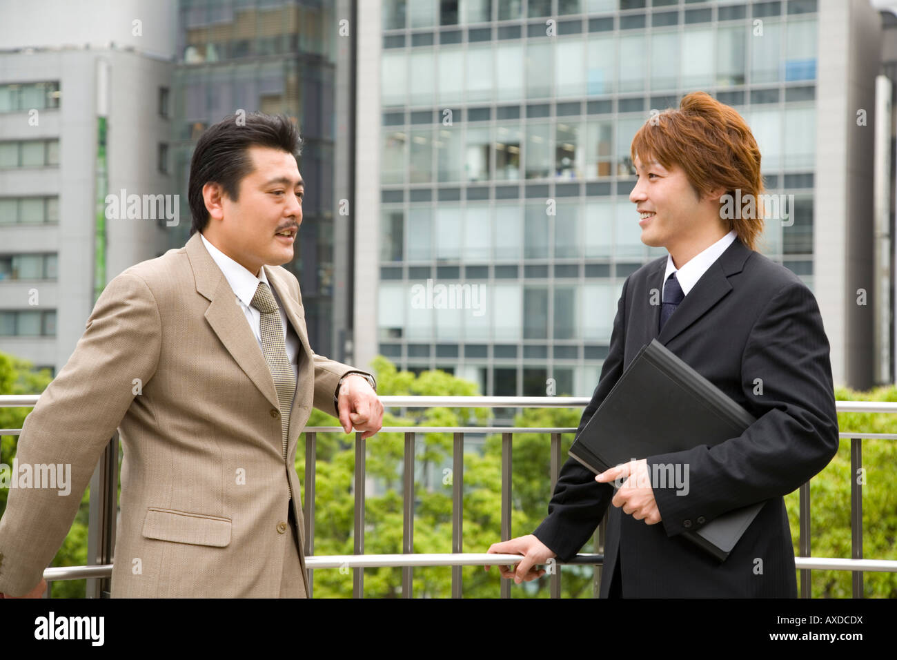 Two businessmen talking Stock Photo - Alamy