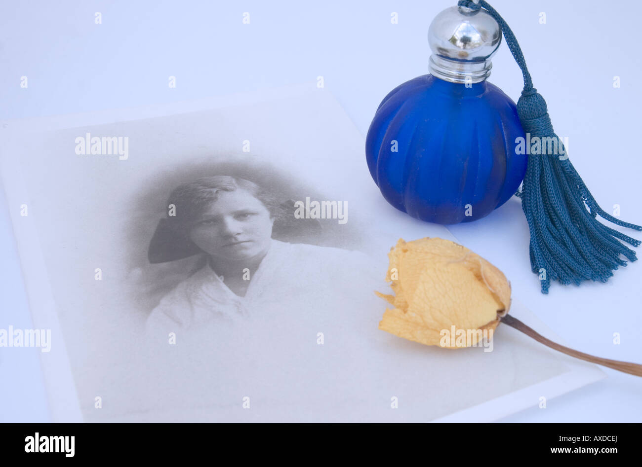Old photograph of woman with pressed yellow rose and blue perfume ...