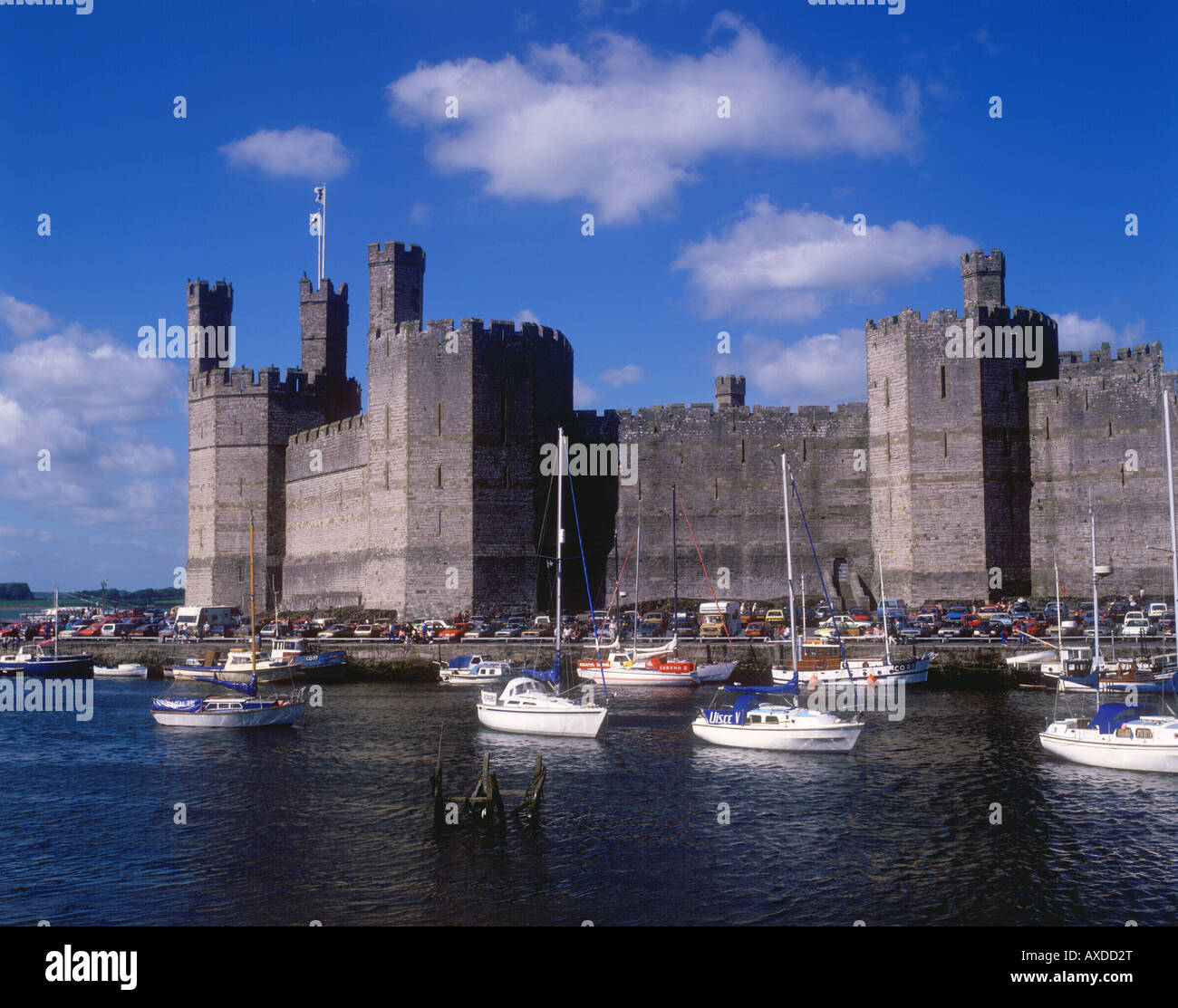 The massive medieval castle at Caernarfon overlooks the small harbour ...