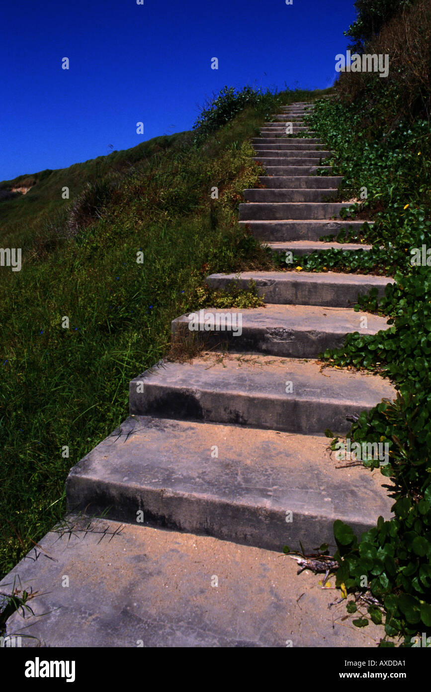 Steps acending up a hill towards a deep blue sky Stock Photo - Alamy
